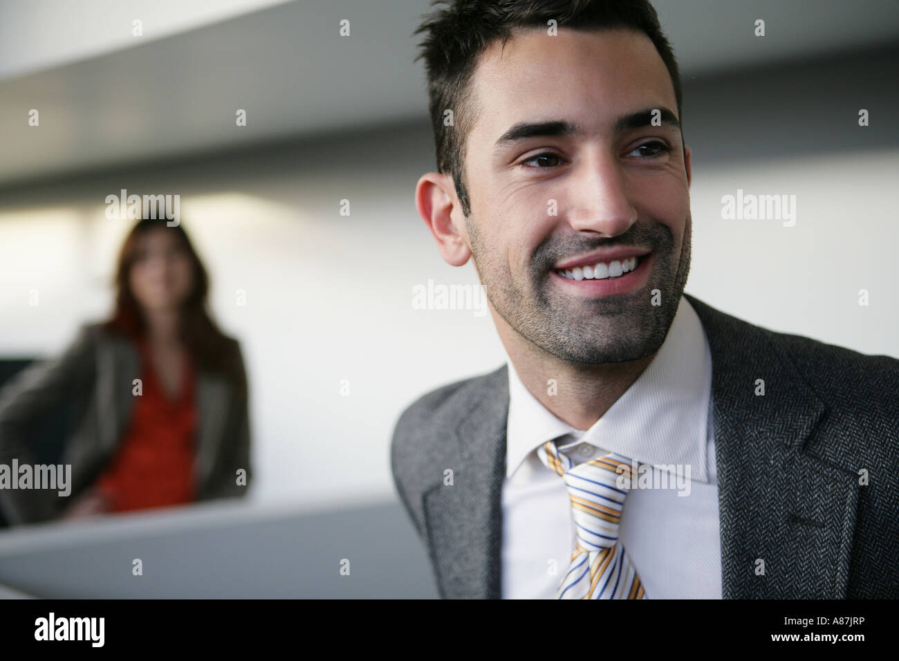 Two business people, woman out of focus Stock Photo - Alamy