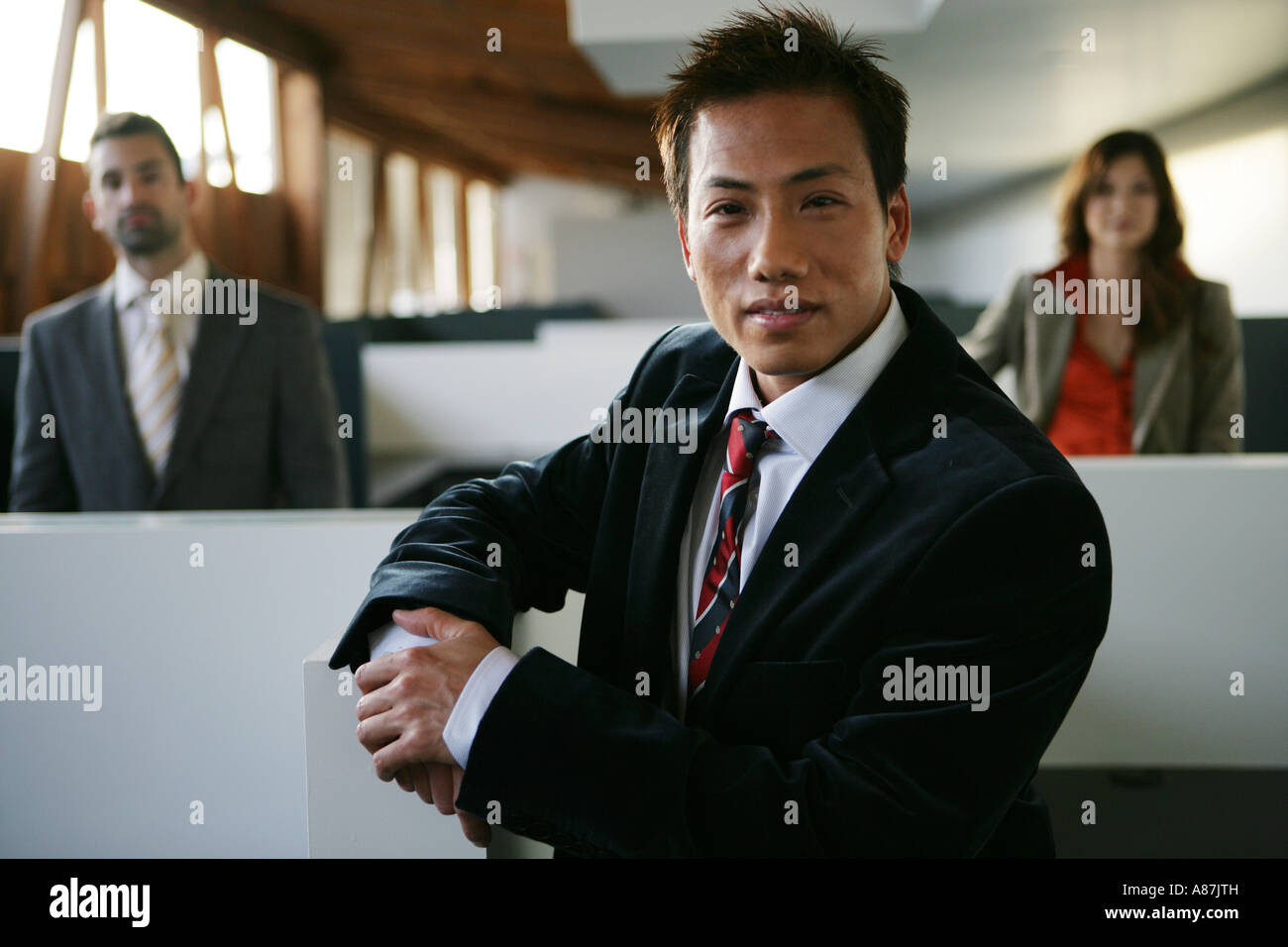 Three business people looking at camera Stock Photo - Alamy