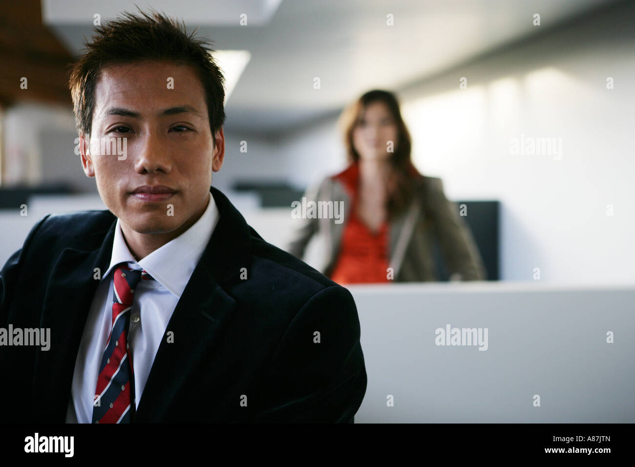 Two business people looking at camera Stock Photo - Alamy