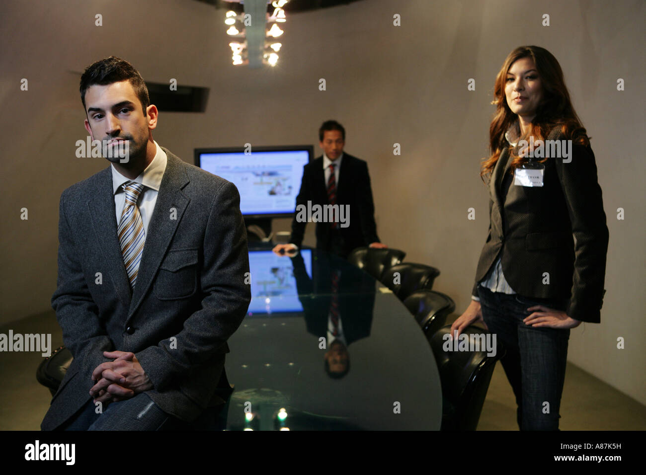 Three people inside a conference room Stock Photo - Alamy