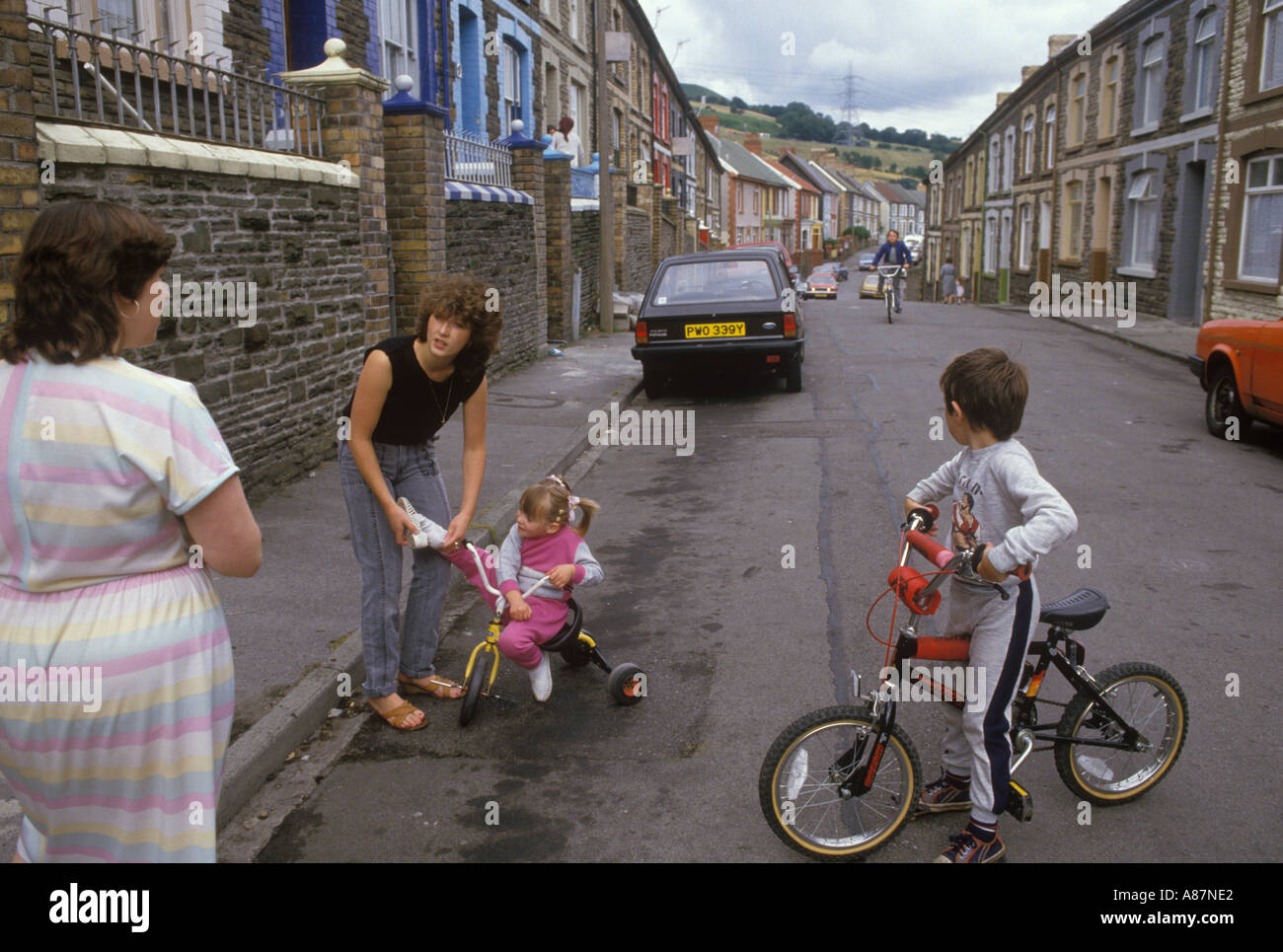 Welsh working class family. Young mother and children playing in street ...