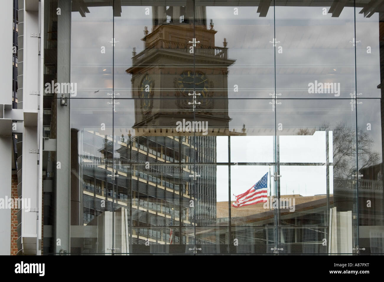 Reflected collage of Independence hall and american flag in glass clad ...