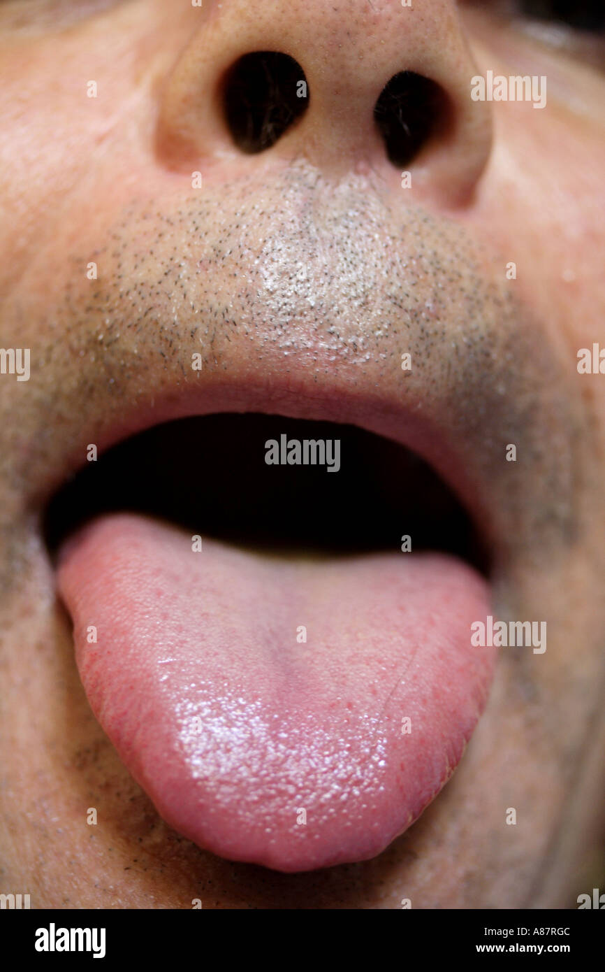 A FIFTY YEAR OLD MAN POKING OUT HIS TONGUE BAPDA6734 Stock Photo - Alamy