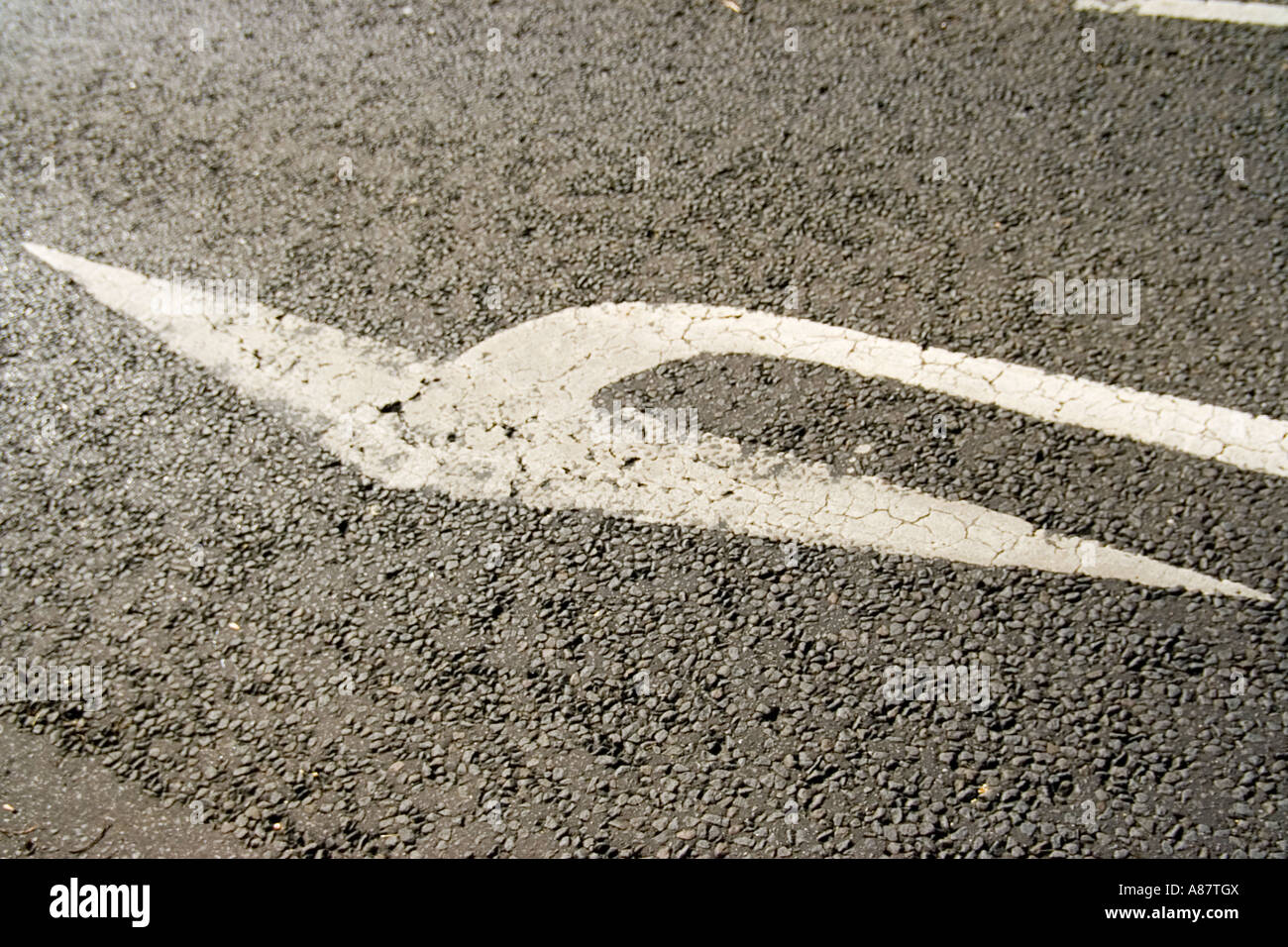White painted direction arrow on road Stock Photo - Alamy