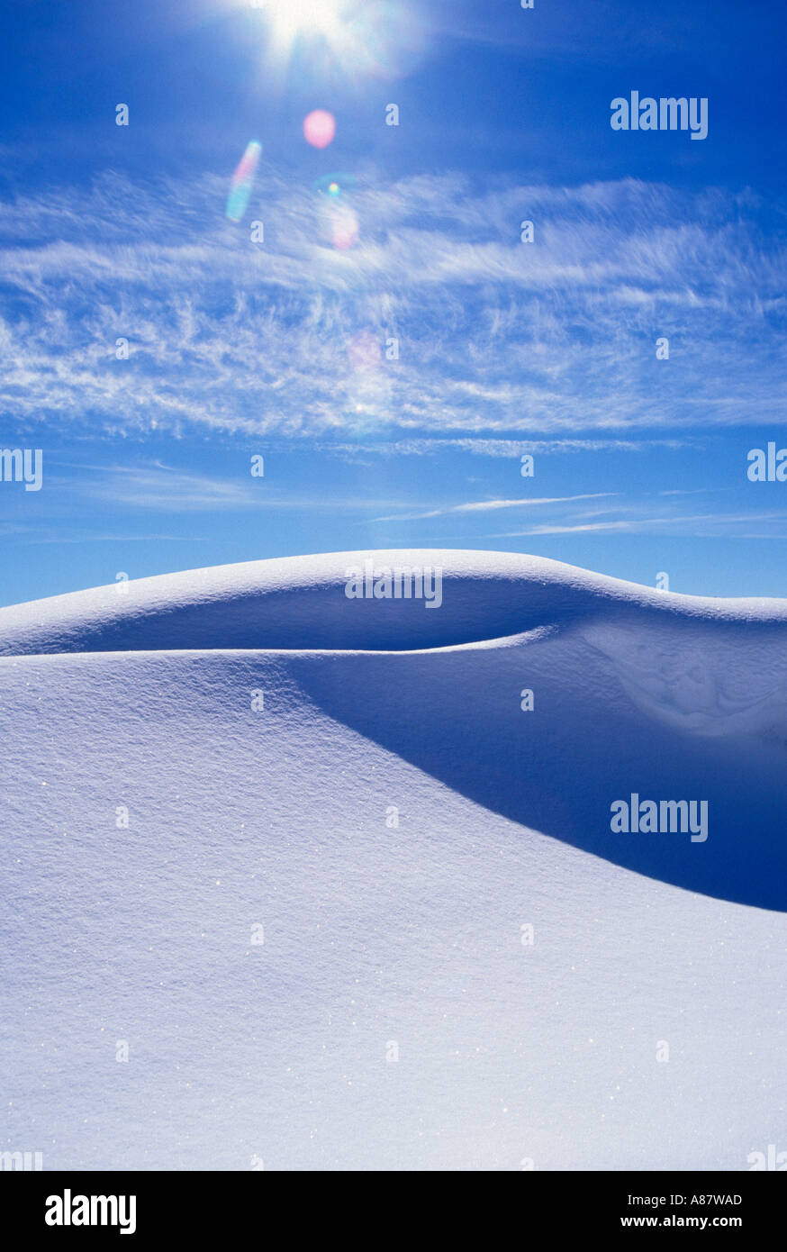 Sun flare and shadows across abstract snow cornice drift in Hayden ...