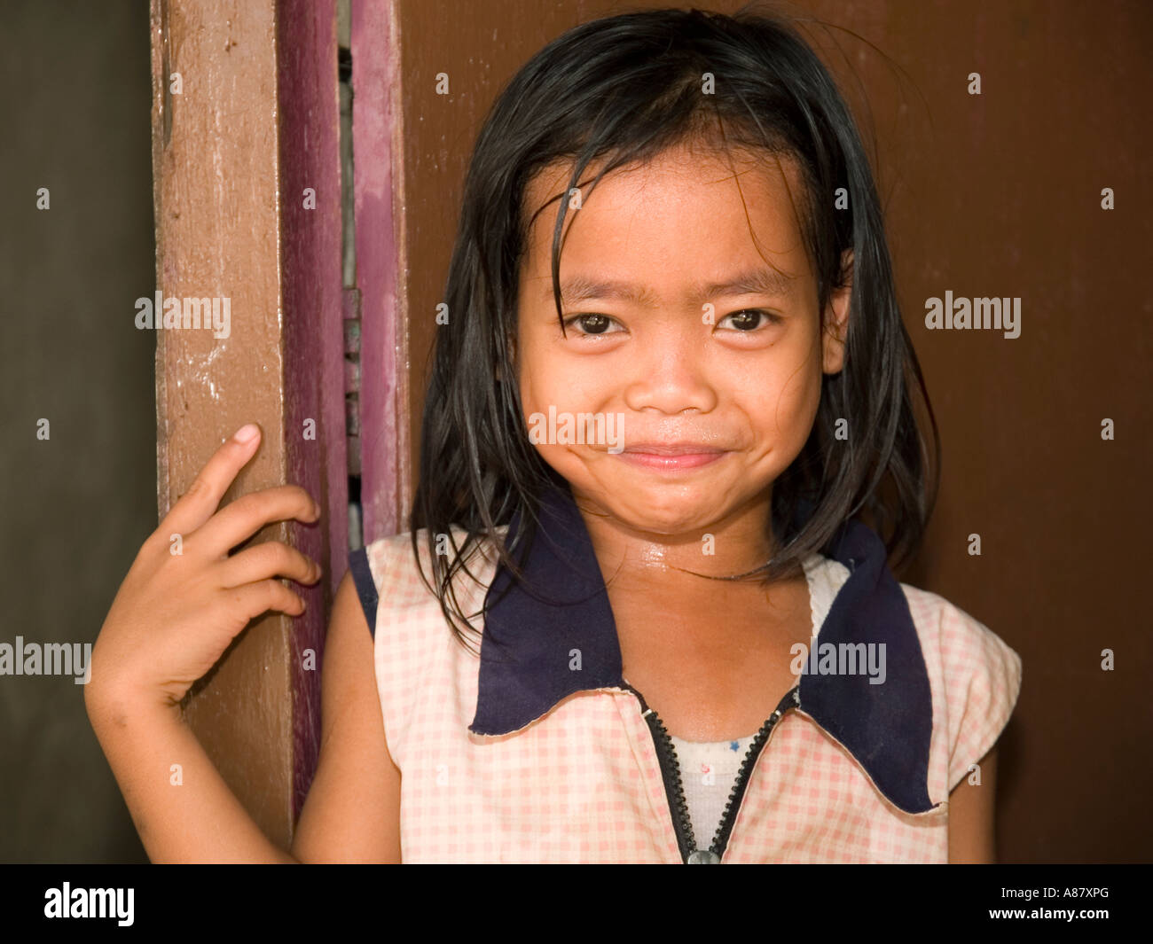 Young smiling local girl in a slum area of Surabaya,Java,Indonesia ...