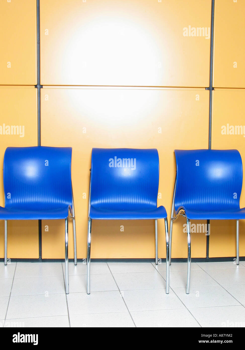Chairs against a wall Stock Photo - Alamy