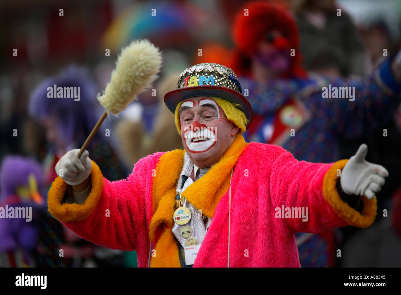 Clowns and a marching band of Spidermen march thorugh the town of ...