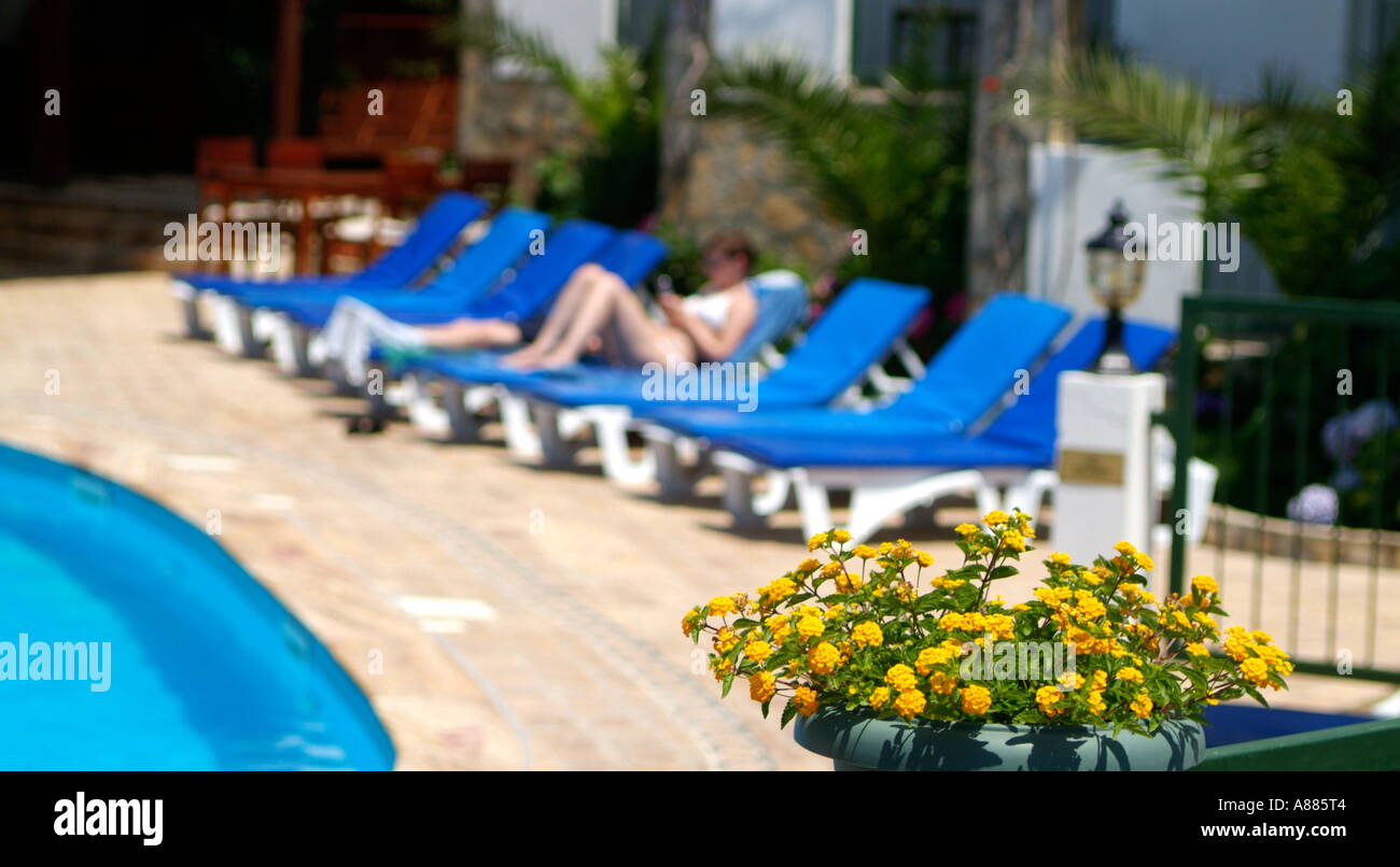 relaxing beside holiday swimming pool Stock Photo - Alamy