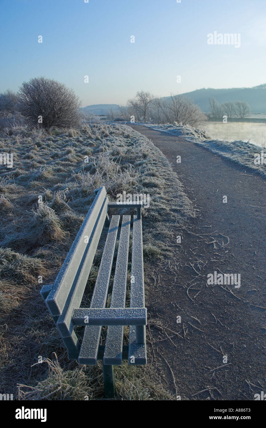 Frost covered bench at the side of the River Trent Attenborough nature ...