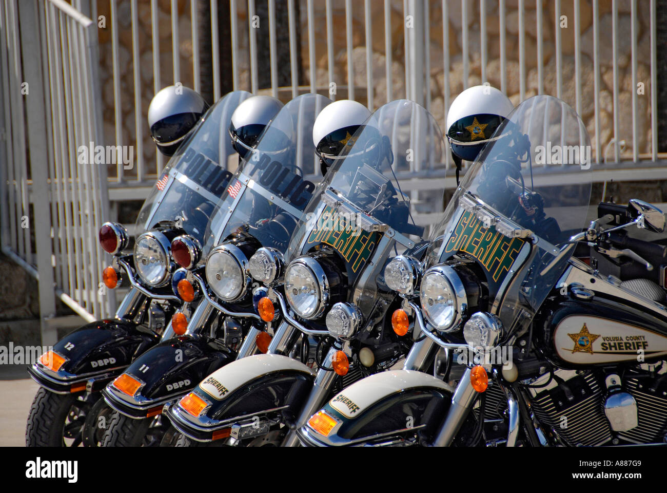 A row of sheriff police motorcycles are parked and lined up ready for ...