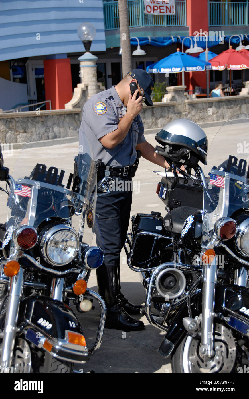 Policeman uses a cellular telephone as part of every day communication ...