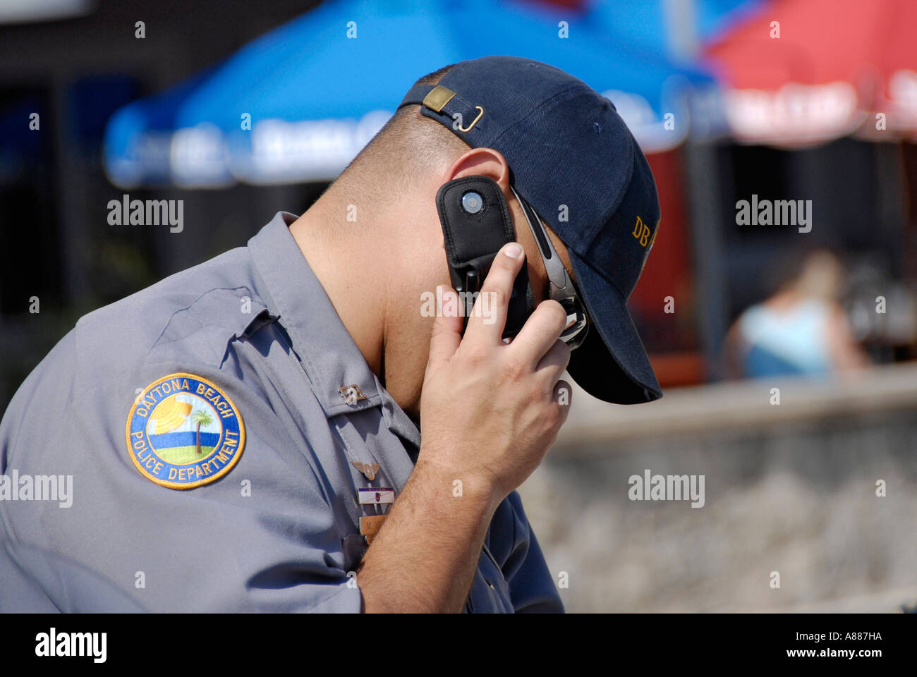 Policeman uses a cellular telephone as part of every day communication ...