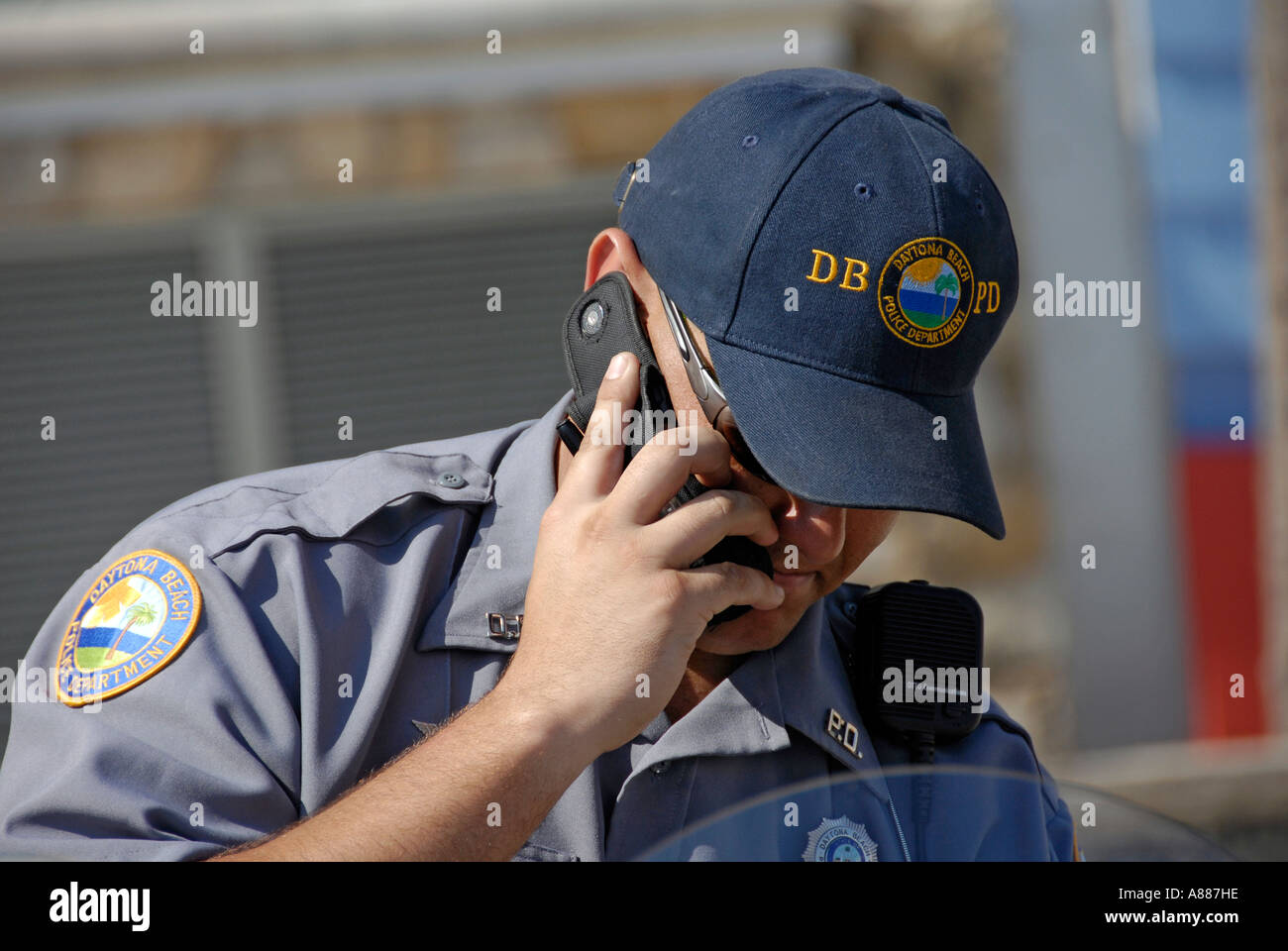 Policeman uses a cellular telephone as part of every day communication ...