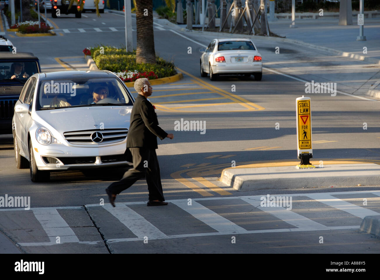 Traffic sign requiring motorists to stop for pedestrians crossing the ...