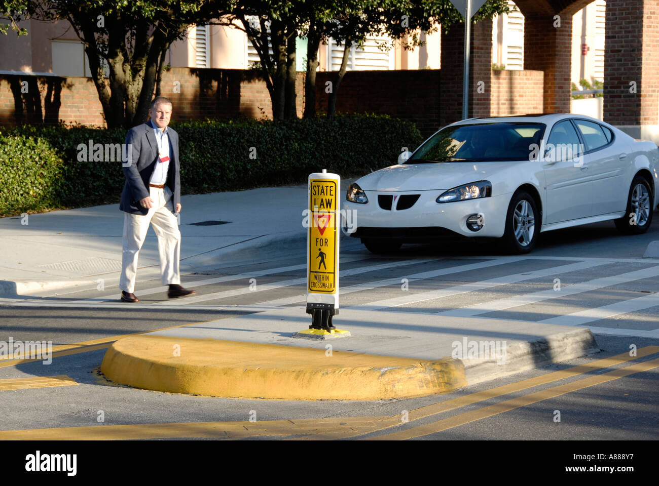 Traffic sign requiring motorists to stop for pedestrians crossing the ...