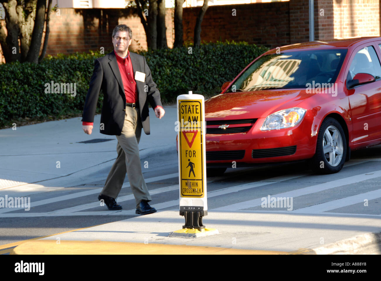 Traffic sign requiring motorists to stop for pedestrians crossing the ...