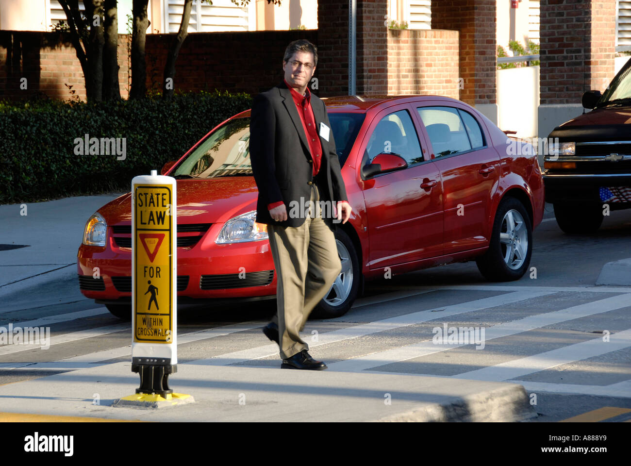 Traffic sign requiring motorists to stop for pedestrians crossing the ...