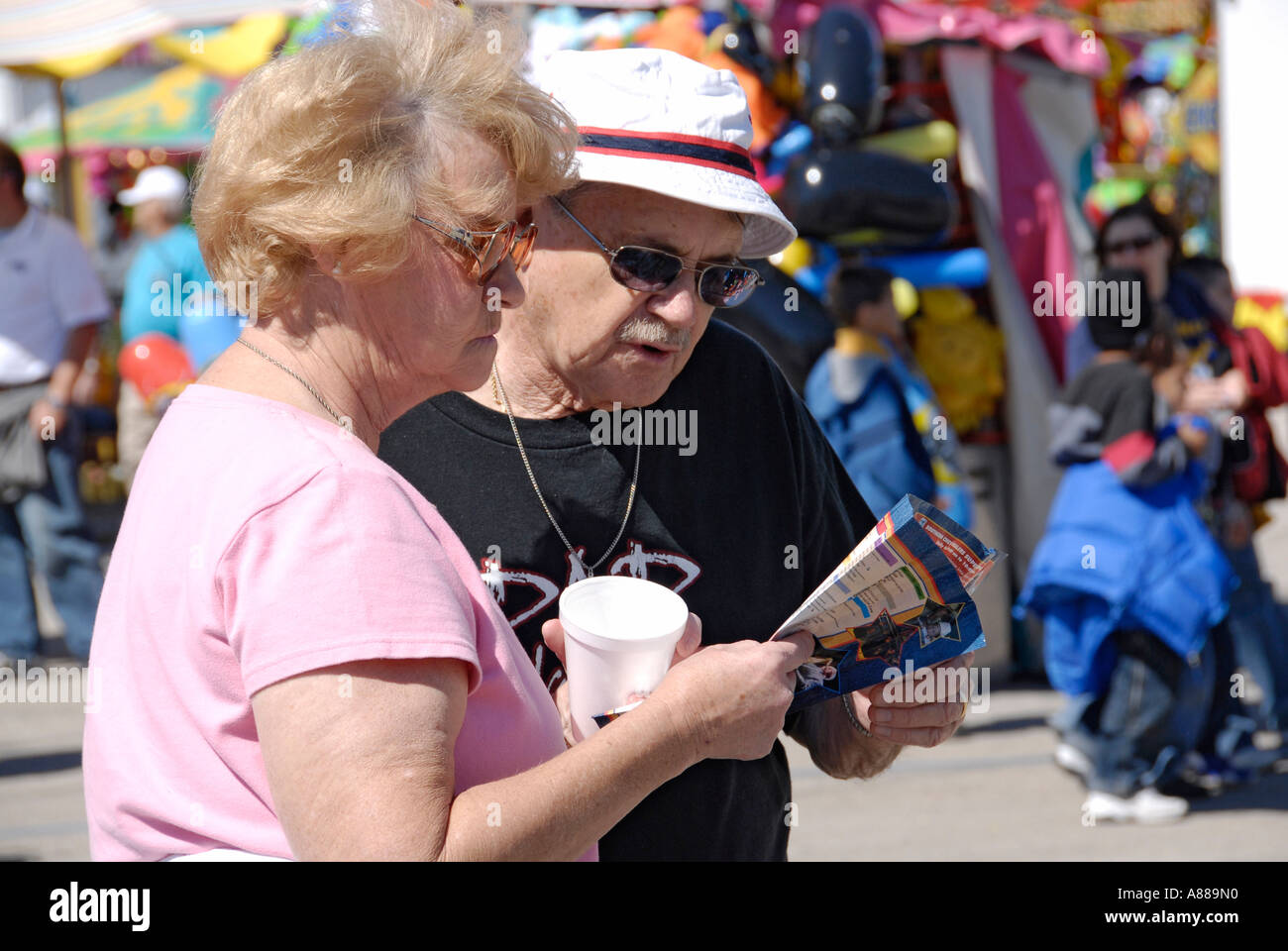 Adult senior man and woman look at a map for directions around the ...