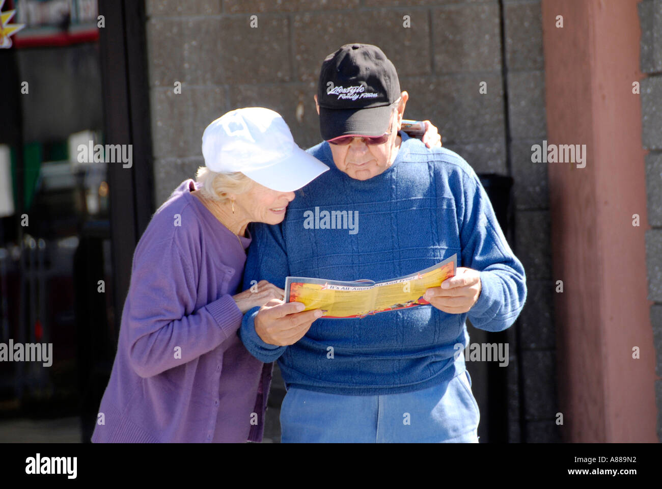 Adult senior man and woman look at a map for directions around the ...