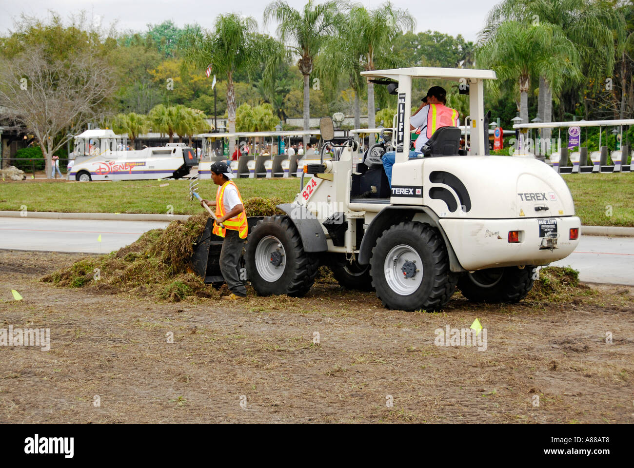 Construction workers clean up and prepare landscape prior to laying new ...