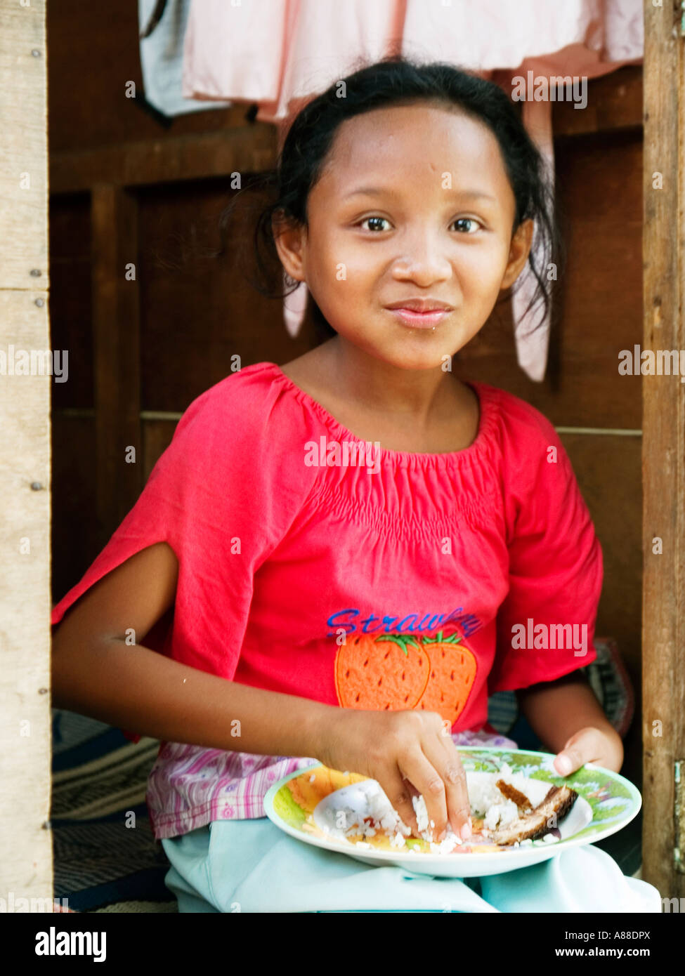 Young girl eating meal in slum area of Surabaya,Java,Indonesia Stock ...