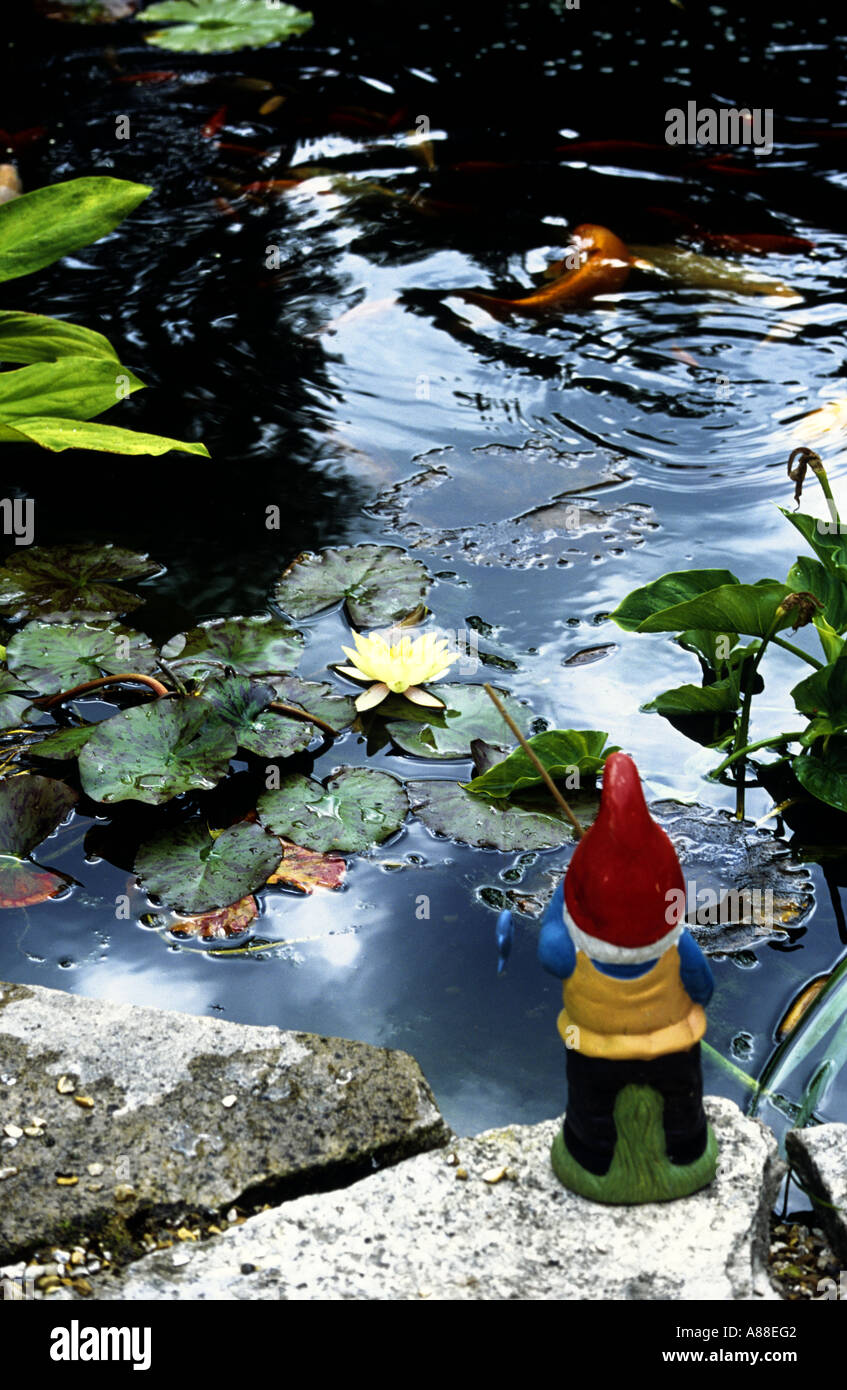 Garden gnome fishing in pond Stock Photo - Alamy