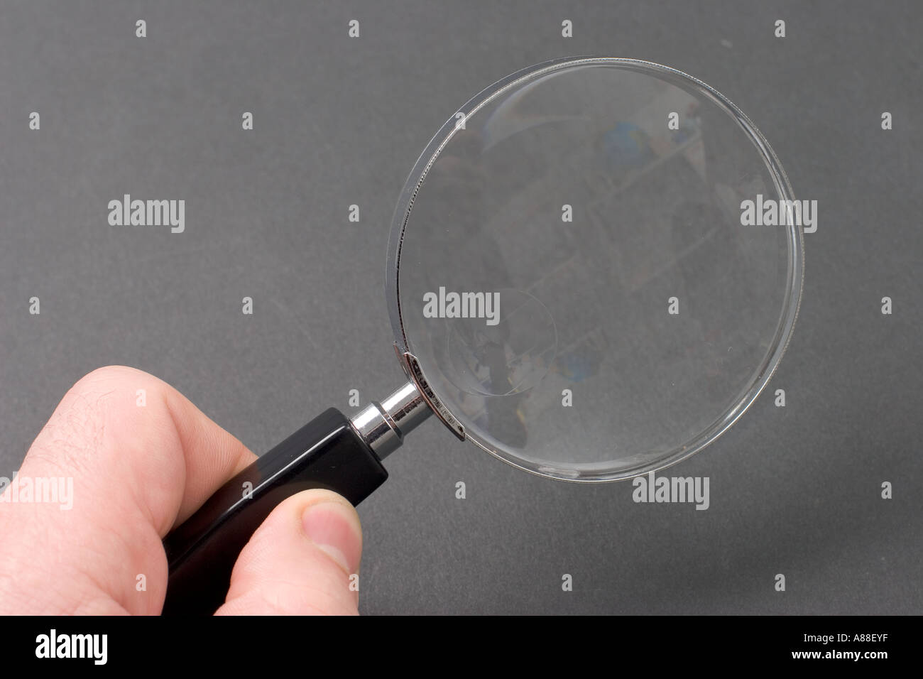 Hand holding magnifying glass Stock Photo - Alamy