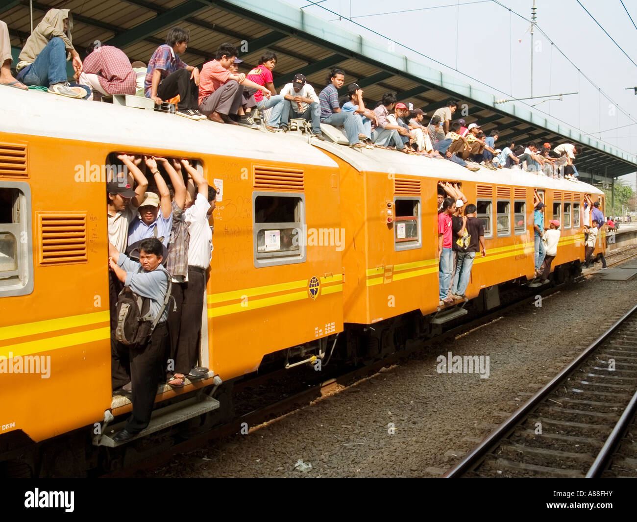 commuters pack a local train including the roof rush hour jakarta ...