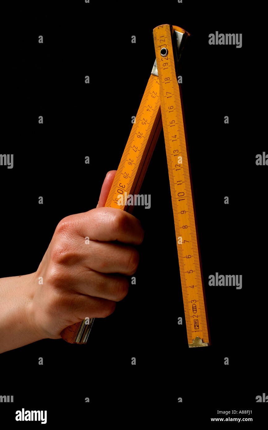 Female hand holds Folding carpenter rule Stock Photo - Alamy