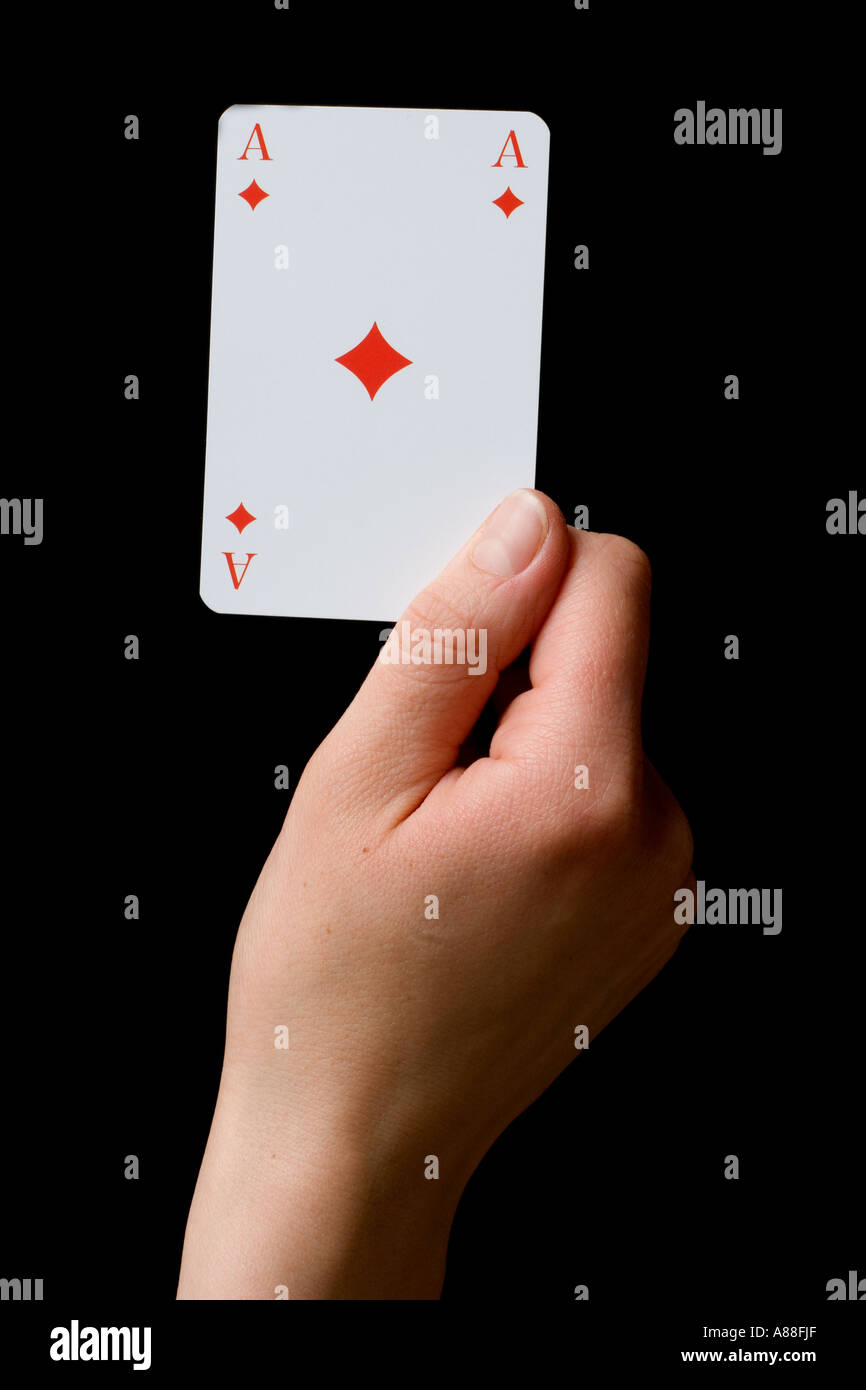 Womans hand holding an ace playing card on black background Stock Photo ...