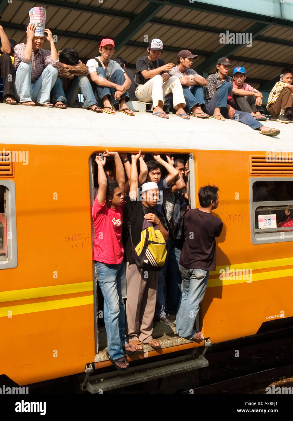 commuters pack a local train including the roof rush hour jakarta ...