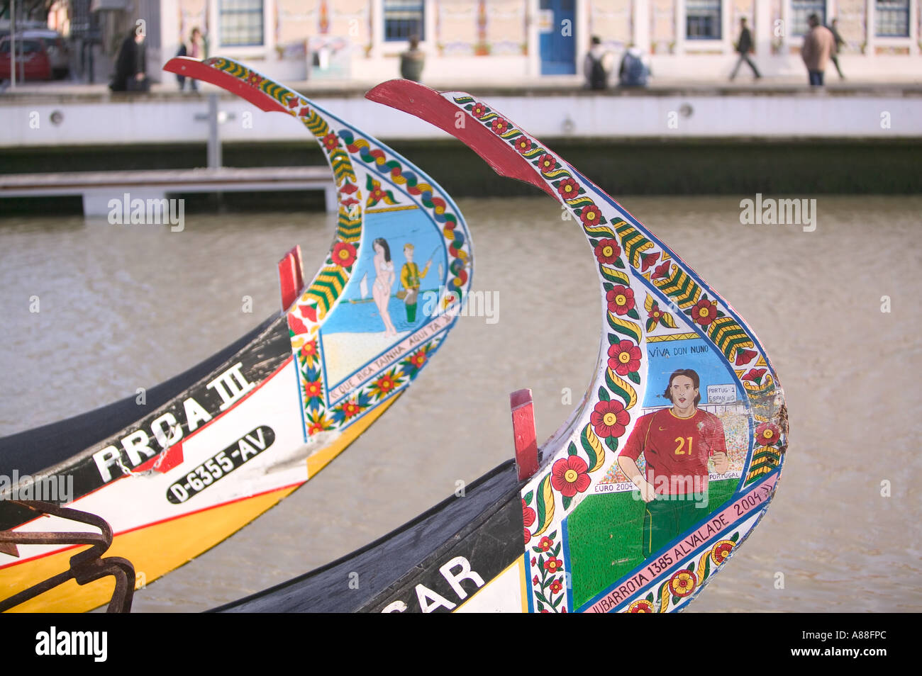hand painted designs on traditional Moliceiro fishing boats on a canal ...