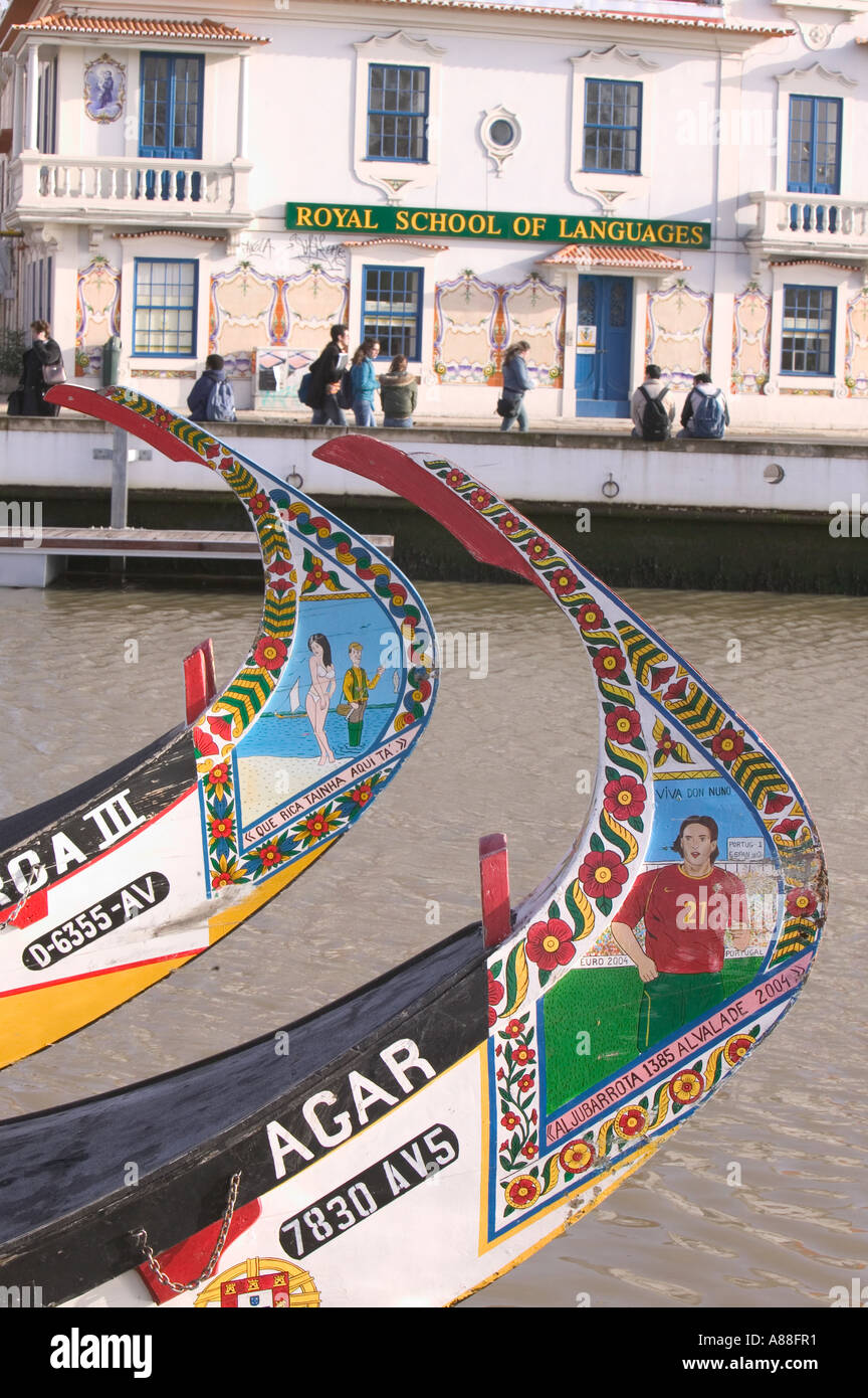 hand painted designs on traditional Moliceiro fishing boats on a canal ...