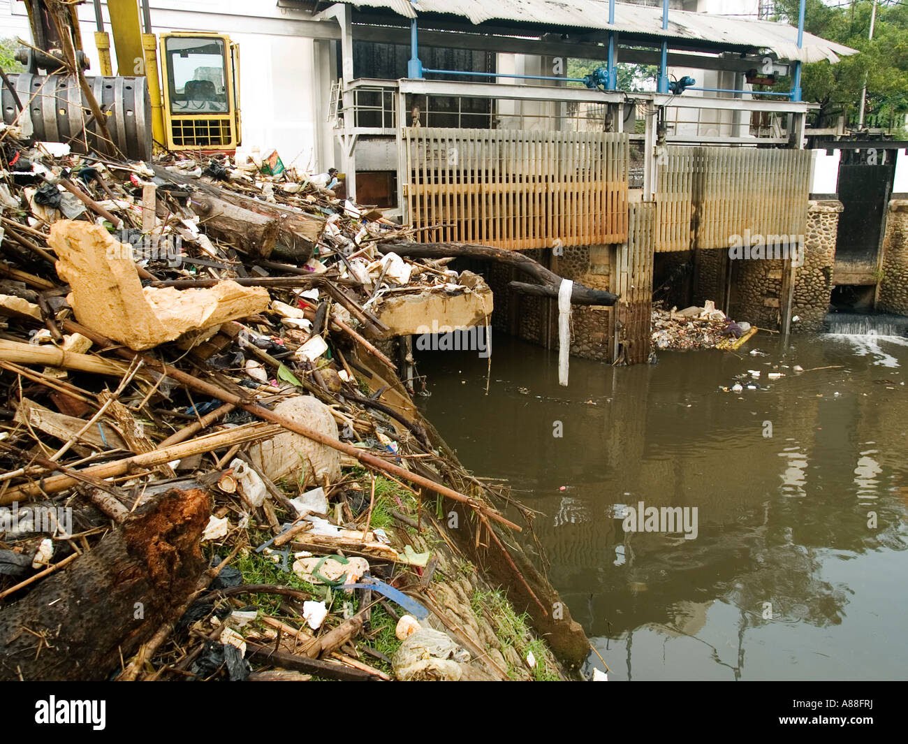 Litter strewn bank dredged from polluted waterway,Jakarta,Java ...