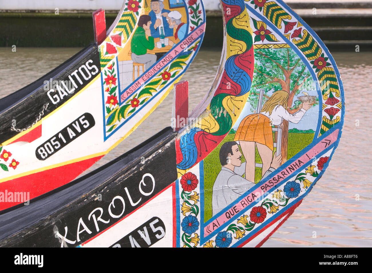 hand painted designs on traditional Moliceiro fishing boats on a canal ...
