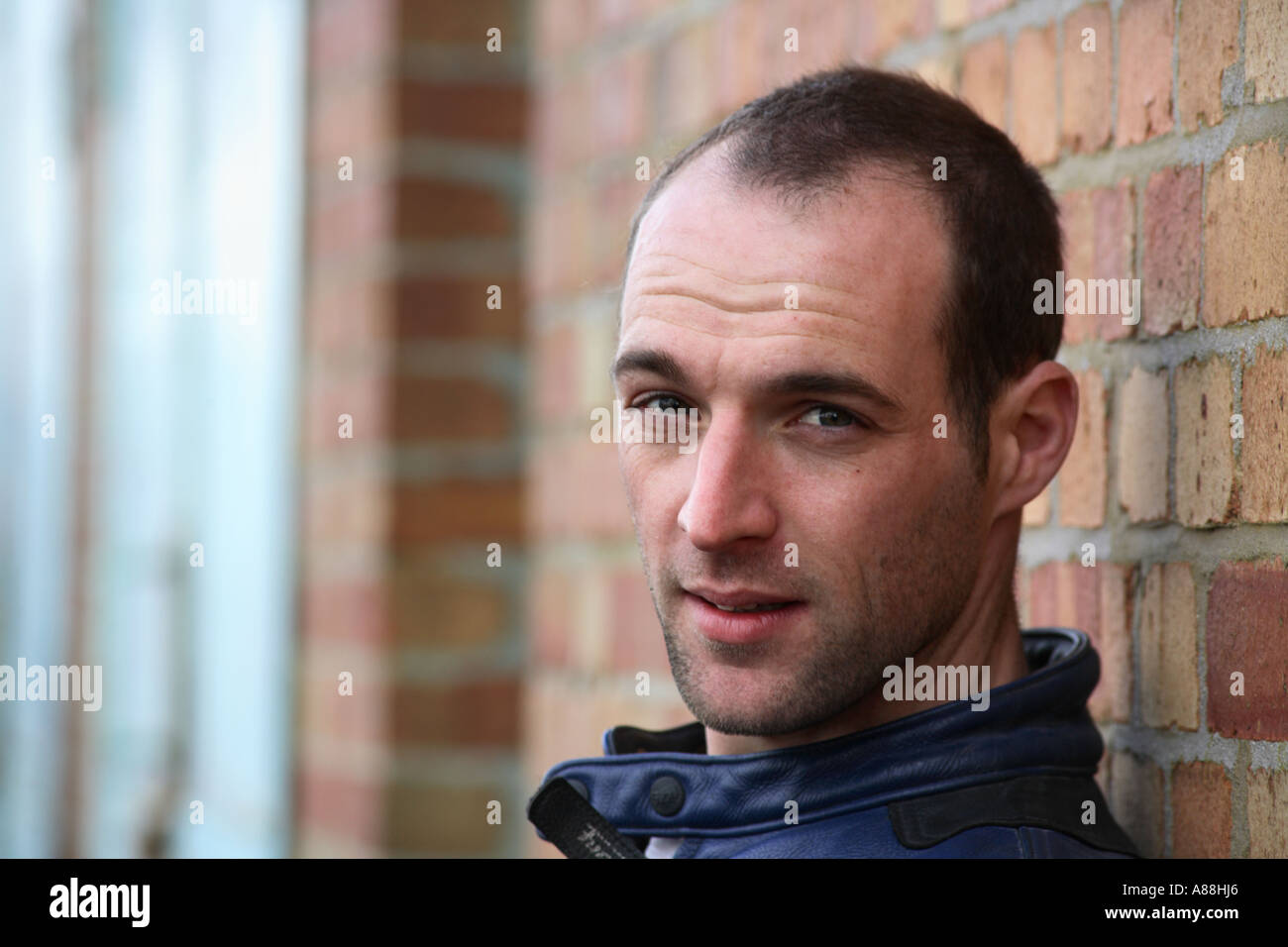 Horizontal close up portrait of young good looking man in leather ...