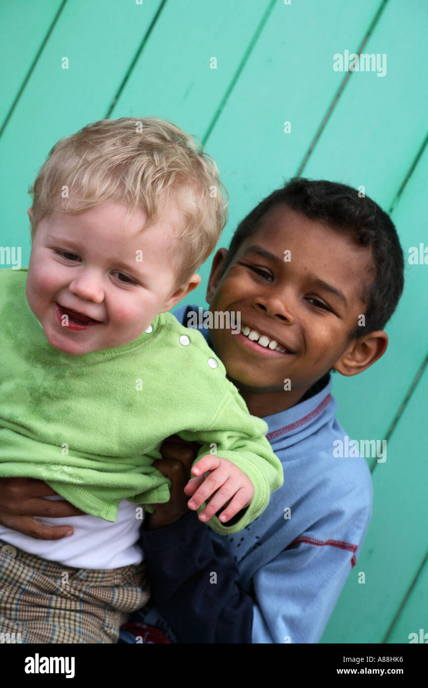 Vertical bright colour portrait of two young brothers, one afro ...