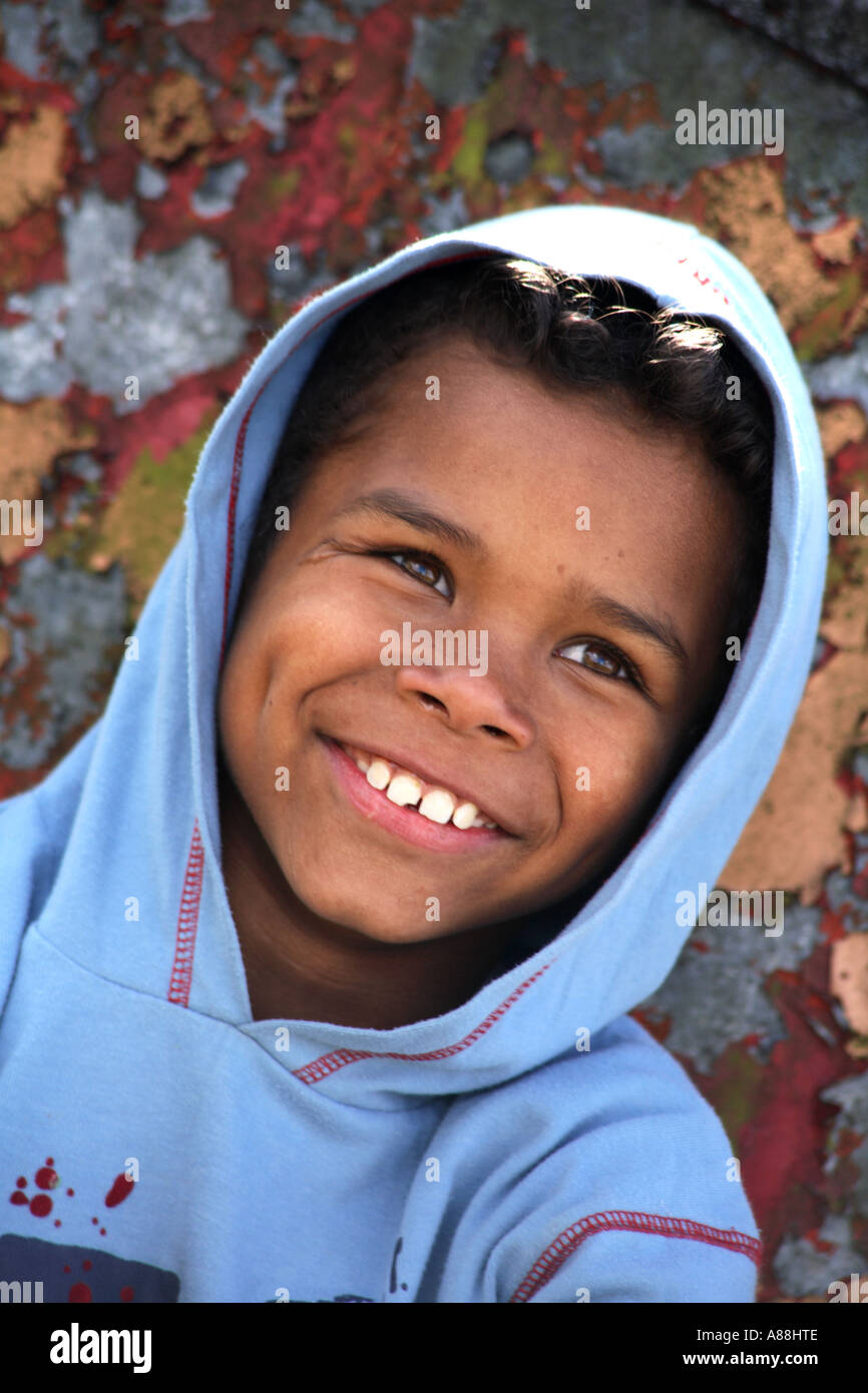 Vertical close up portrait of young afro caribbean boy smiling in ...