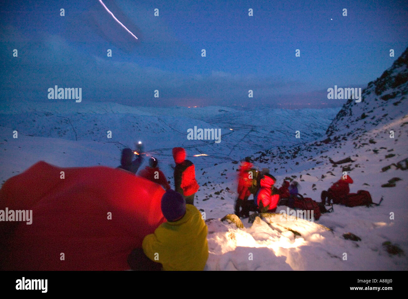 a mountain rescue team perform a night rescue in Winter, Red Screes ...