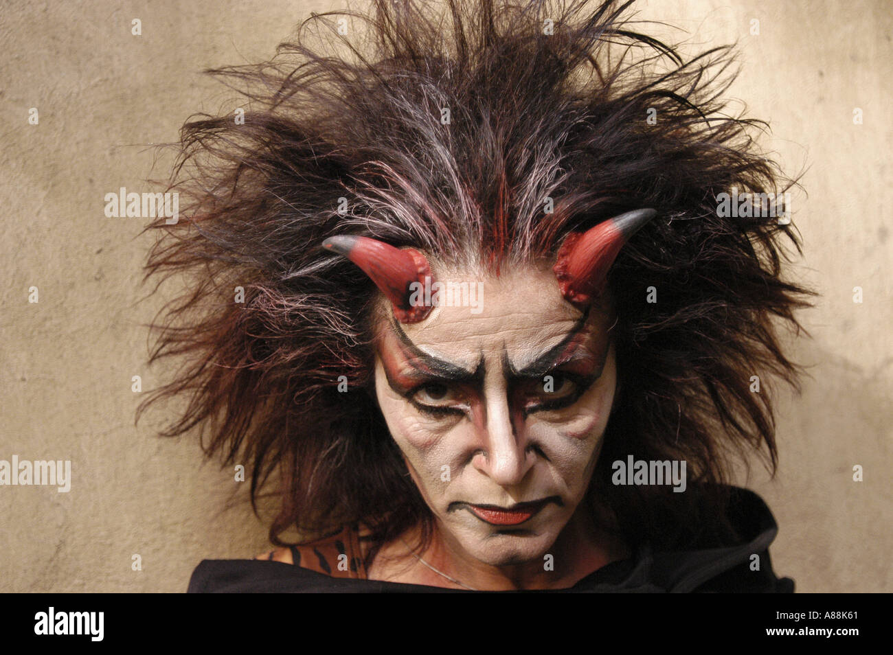 Female horned devil looking at camera Stock Photo - Alamy