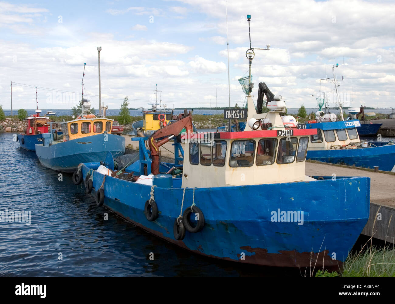 Blue painted Finnish fishing trawlers at harbor at Oulunsalo Finland ...