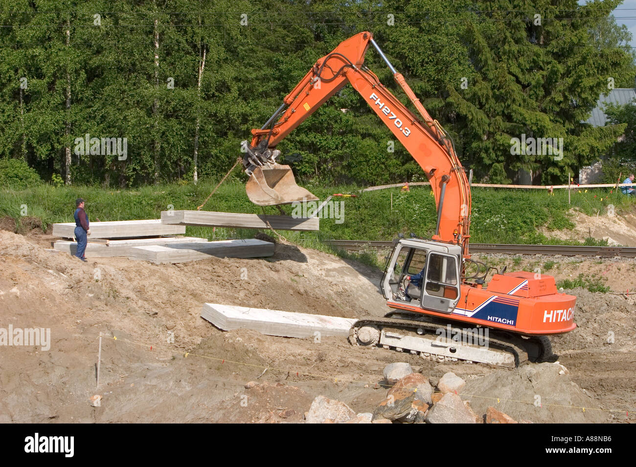 Digger lifting a concrete slab in a construction site , Finland Stock ...