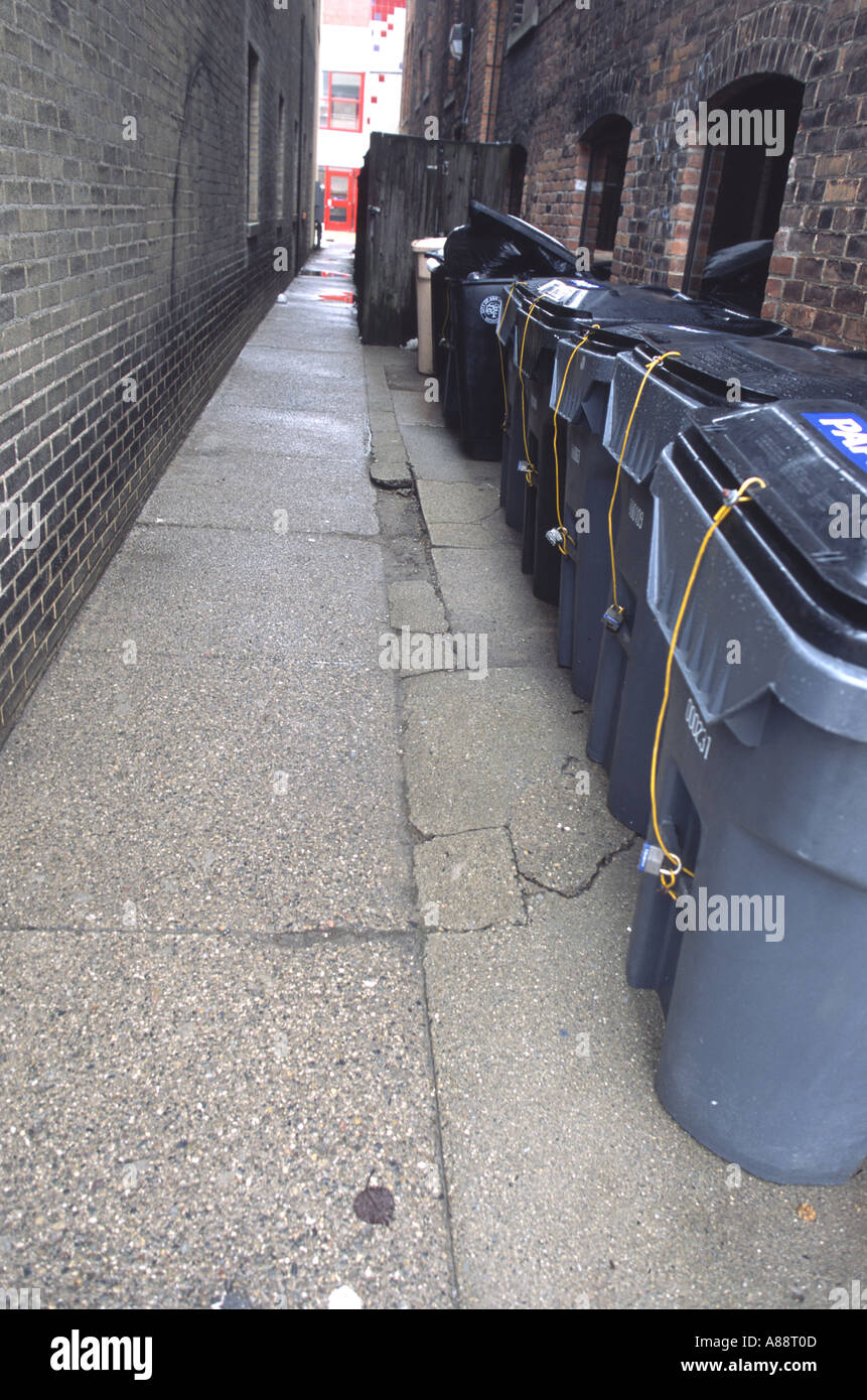 Trash cans in alley Stock Photo - Alamy