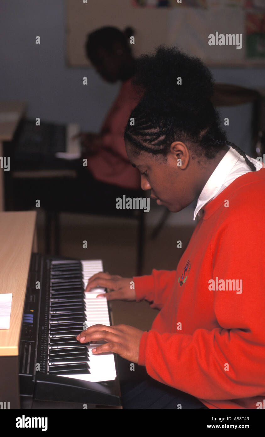 School pupil in music class playing piano, Southwark, London, UK Stock ...