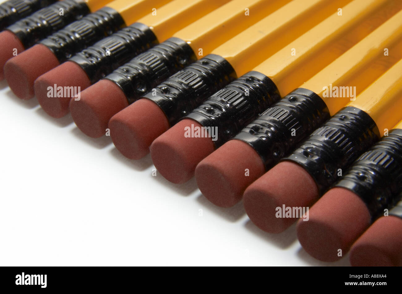 Row of orange pencils on a white background eraser ends Stock Photo - Alamy
