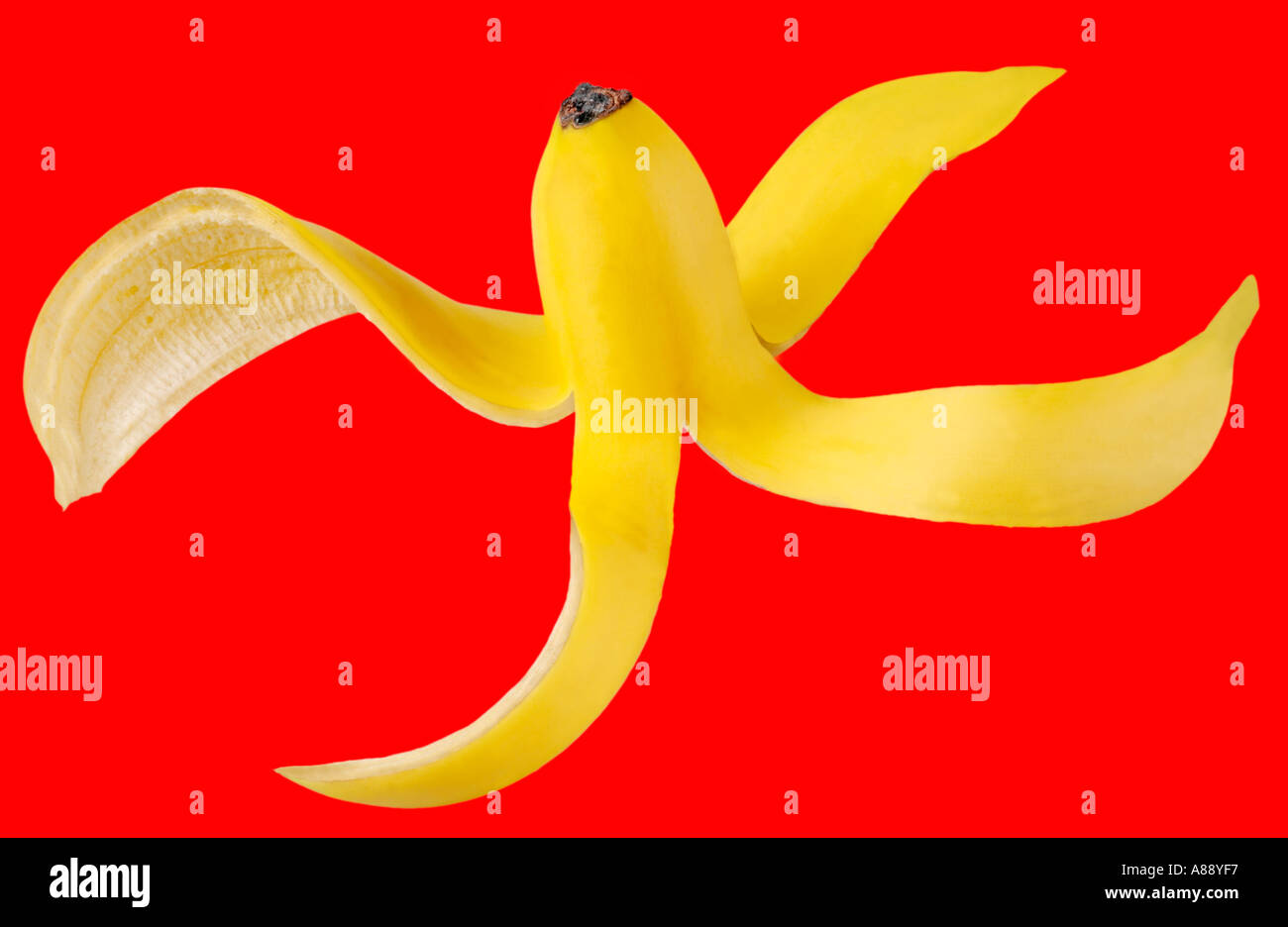 BANANA SKIN ON RED Stock Photo - Alamy