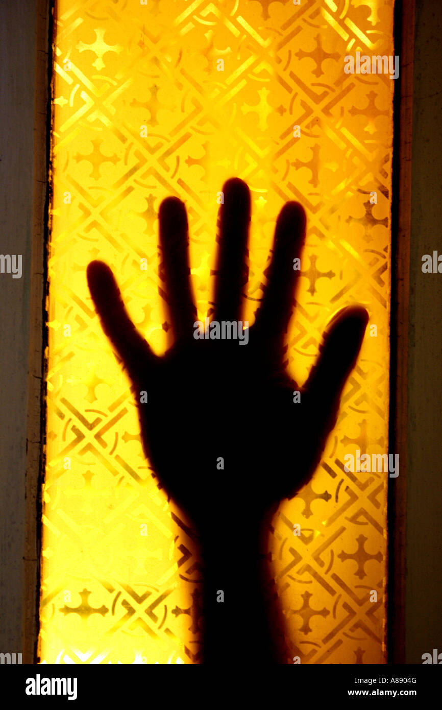 THE SHADWO OF A HAND IN THE WINDOW BDA10554 VERTICAL Stock Photo - Alamy