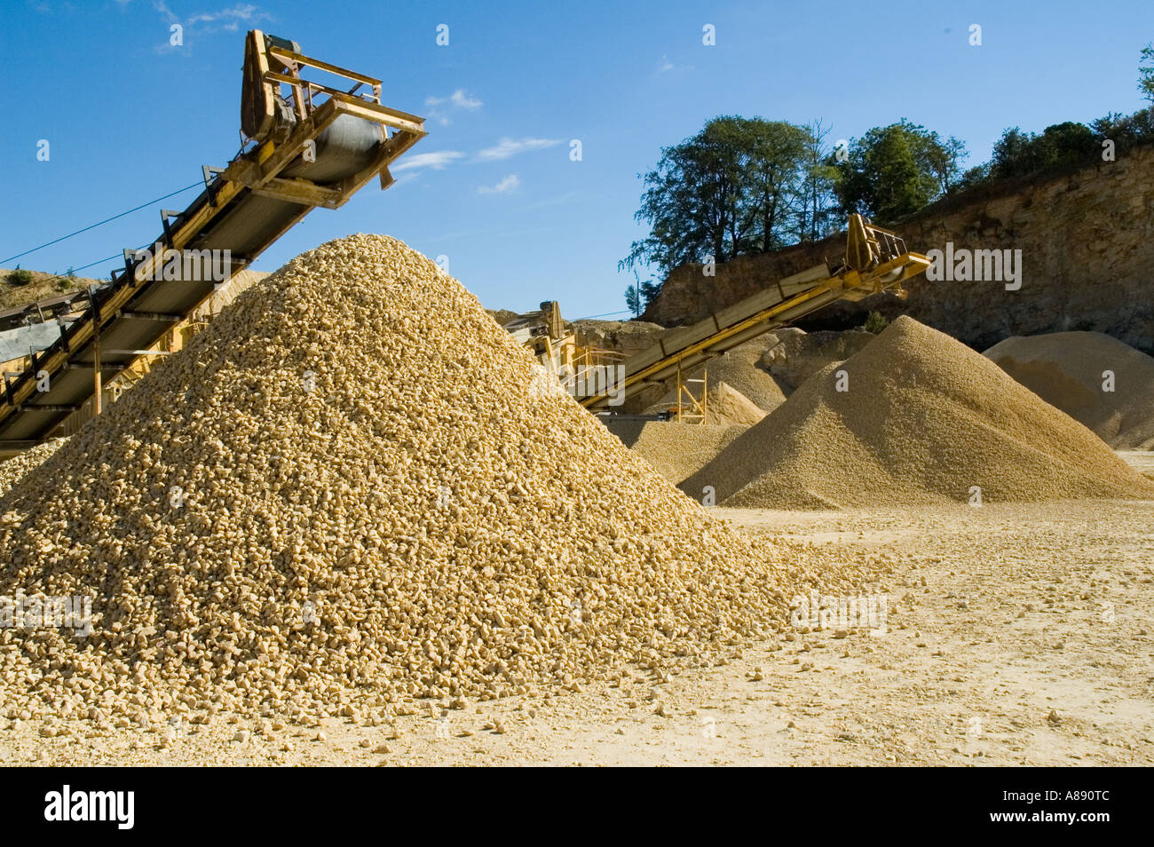 Stockpiles of crushed stone at a sandstone quarry in Yorkshire, England ...