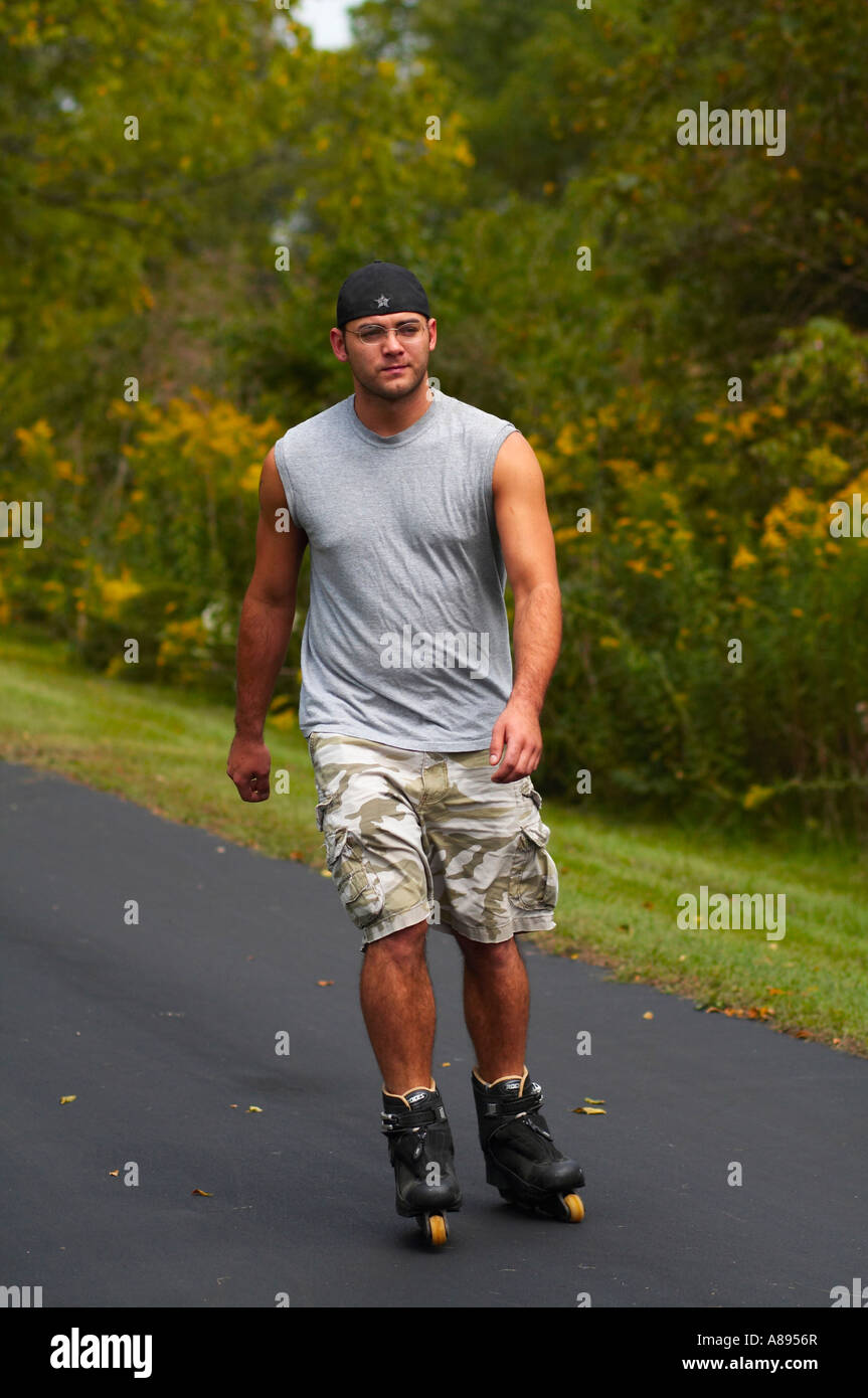 A man in his 20 s skating on inline skates on a bike path Stock Photo ...
